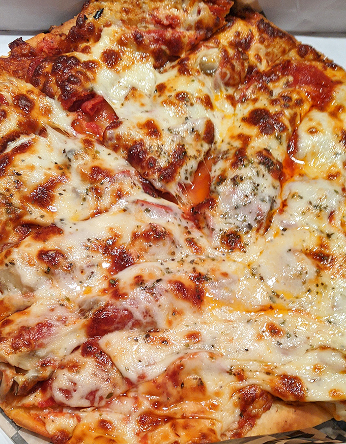 Behold the pepperoni pizza in all its glory—those crispy-edged cups of pepperoni holding little pools of flavor are what dreams are made of.