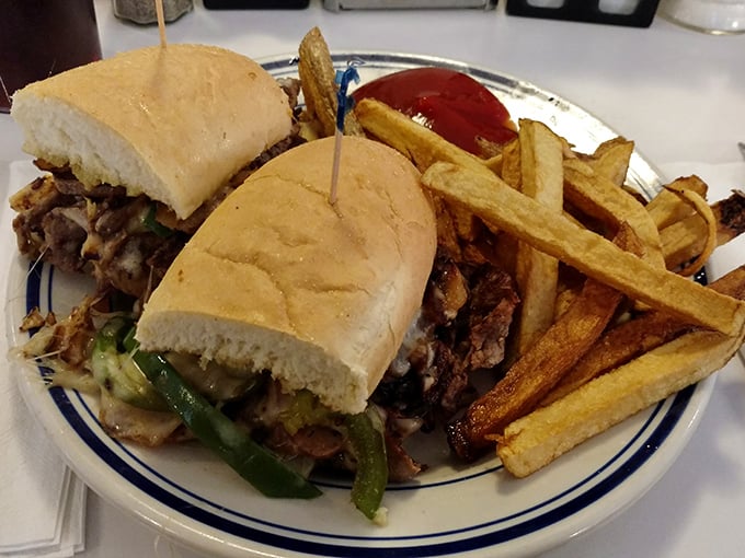 Behold the star of the show: Johnny's Philly cheesesteak with hand-cut fries. That perfect meat-to-cheese ratio isn't just a sandwich—it's edible poetry.