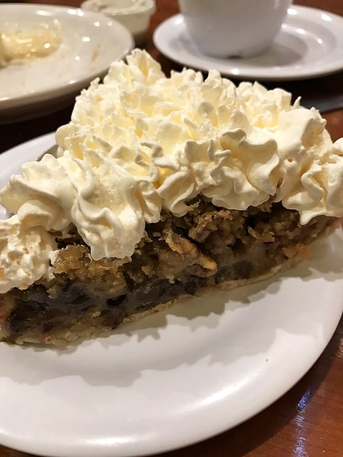 Meet the pie that launched a thousand diet breaks. That mountain of whipped cream isn't just a topping—it's a fluffy white flag of delicious surrender.