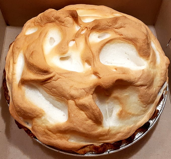 Behold the meringue mountain! This towering creation isn't just dessert—it's architecture with a sweet tooth and a showstopper's personality.