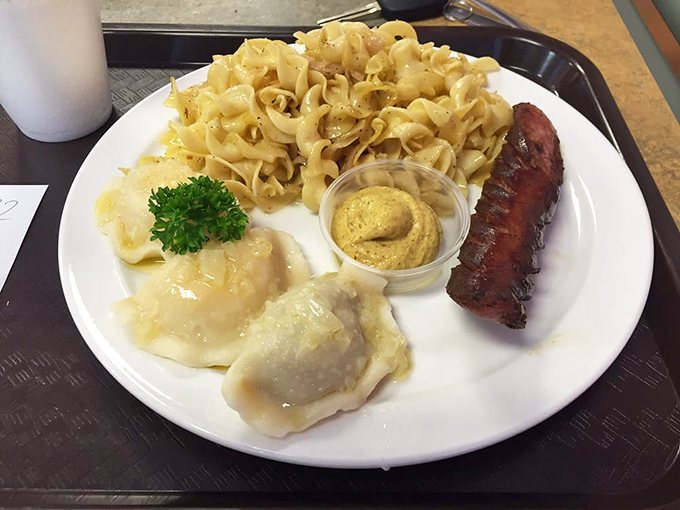 The holy trinity of Polish cuisine: pierogi glistening with butter, haluski noodles waiting to comfort you, and kielbasa that snaps with smoky authority.