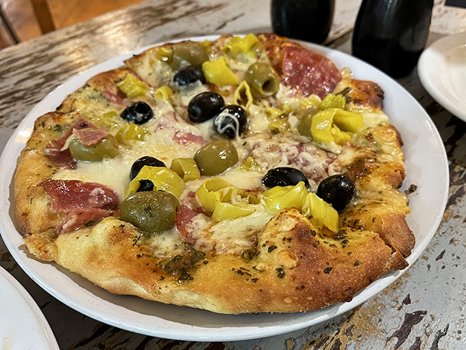 This isn't just pizza—it's edible art with a perfectly blistered crust, melty cheese, and toppings arranged with the care of a Renaissance painter.