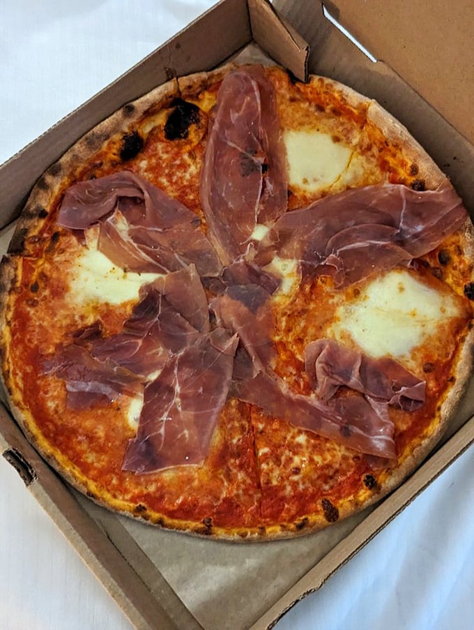 This prosciutto-topped masterpiece isn't just pizza—it's edible architecture where each slice delivers that perfect balance of crispy, chewy, salty, and sublime.