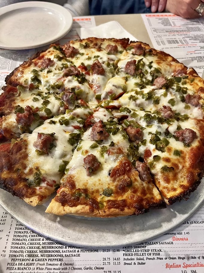 This isn't just pizza—it's edible artwork. Sausage and peppers scattered across melted cheese like confetti at the world's most delicious parade.