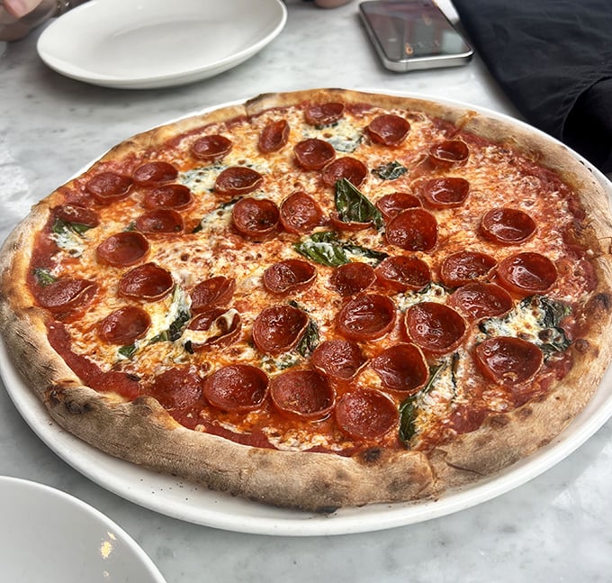 Pizza perfection doesn't exi— oh wait, it does. That leopard-spotted crust, those perfectly curled pepperoni cups collecting flavor pools of deliciousness.