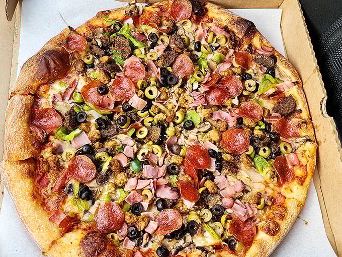 Behold the "All-Pie" in its loaded glory – a pizza so generously topped it makes minimalists weep and maximalists rejoice.