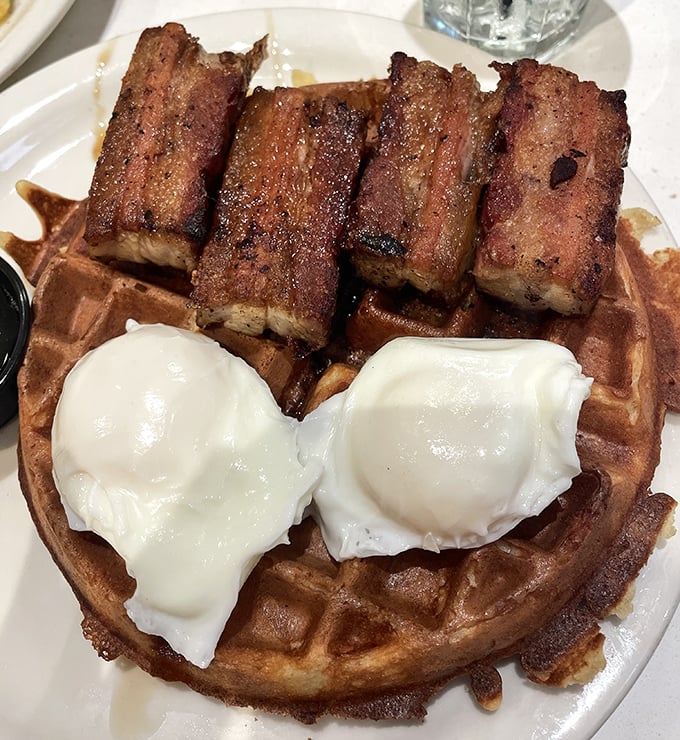 Behold the pork belly waffle in its natural habitat—crispy, savory, sweet, and topped with poached eggs that ooze perfection when pierced.