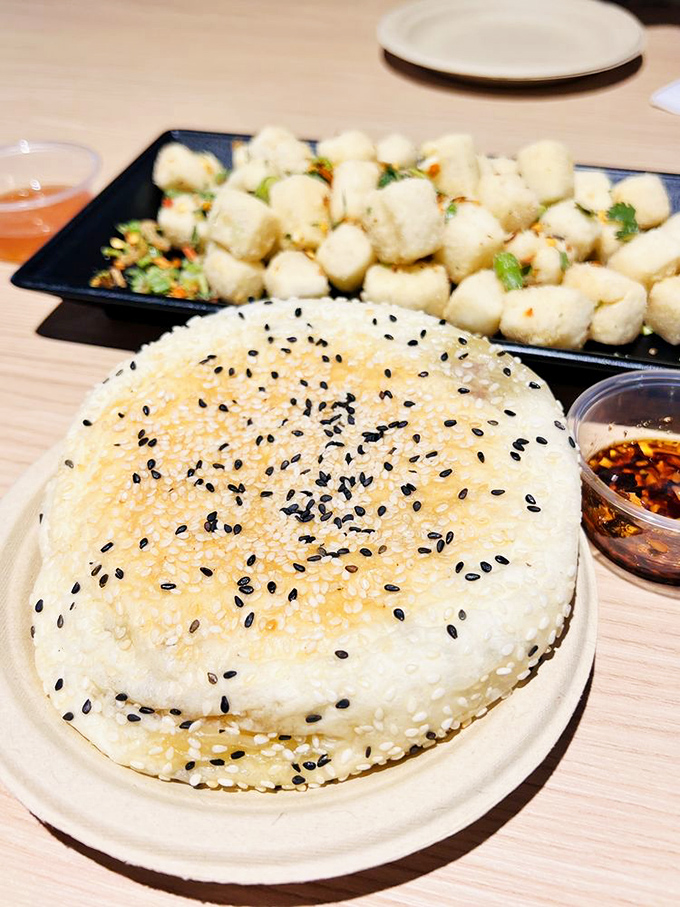 This sesame-topped bun with its bite-sized companions isn't just food—it's an edible work of art that makes your standard dinner roll look like it needs therapy.