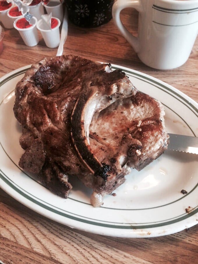 Behold the star of the show! This pork chop isn't just thick – it's the bodybuilder of pork chops, with a perfect sear that should be in a museum.