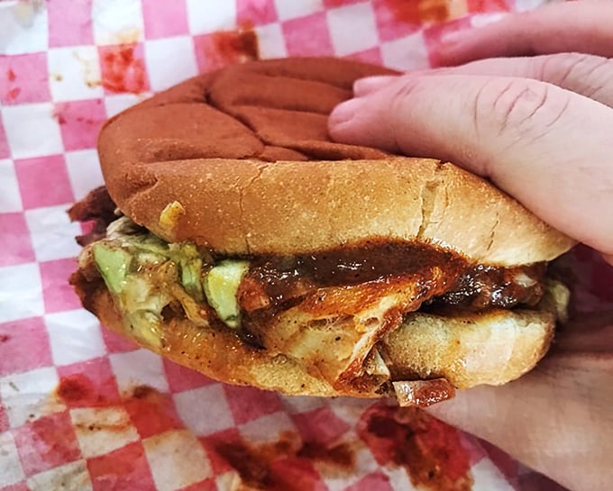 This isn't just a sandwich—it's edible architecture where smoke-kissed pork and tangy slaw create the perfect bite.