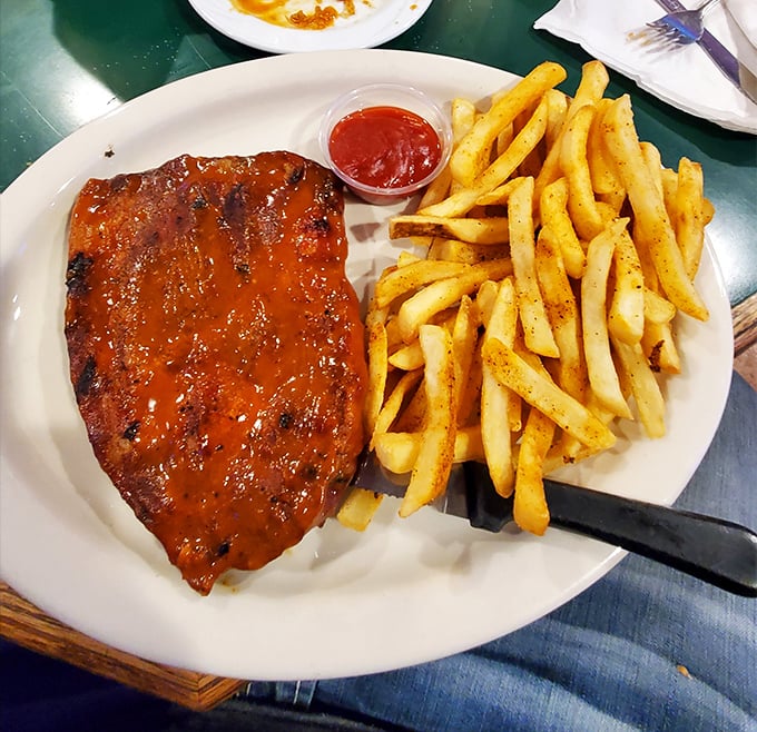 This pork steak isn't just dinner—it's a commitment to excellence with a side of perfectly seasoned fries standing at attention.