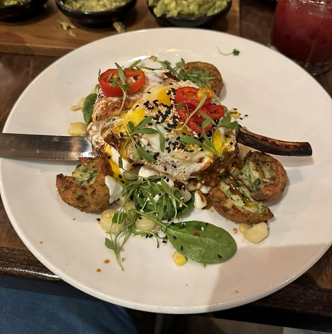 This isn't just a pork chop; it's a masterpiece of protein poetry, where every colorful garnish plays a supporting role in the delicious drama.