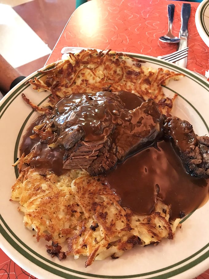 Pot roast for breakfast? Absolutely revolutionary. Tender beef swimming in gravy alongside crispy hash browns—morning comfort that hugs your soul.