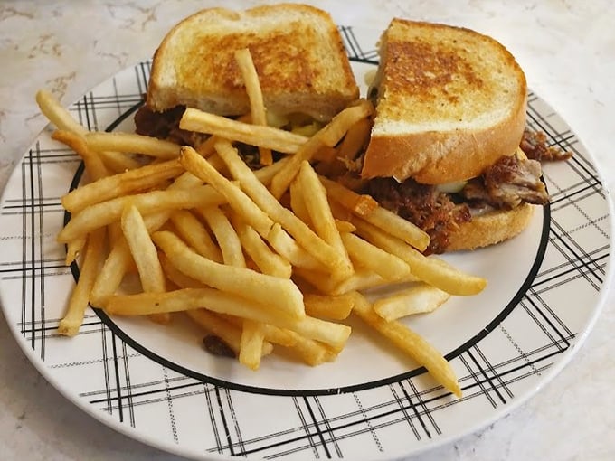 The legendary pot roast sandwich – tender beef nestled between perfectly grilled bread with fries that demand equal attention.
