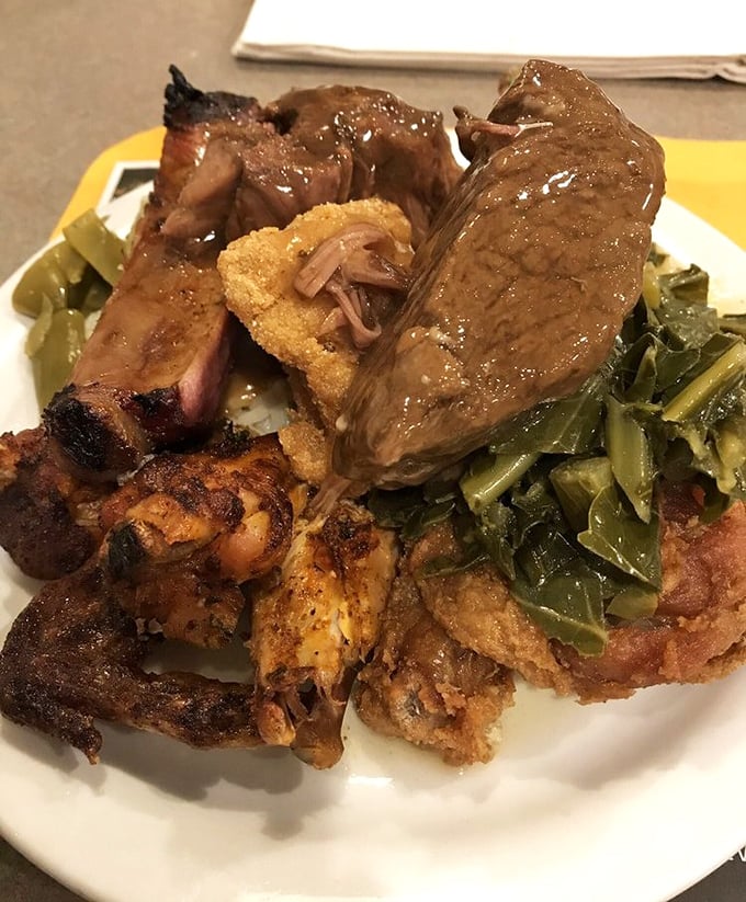 A plate that tells the whole story – smoked ribs, pot roast, fried chicken, and collard greens coexisting in perfect harmony like the world's most delicious family reunion.