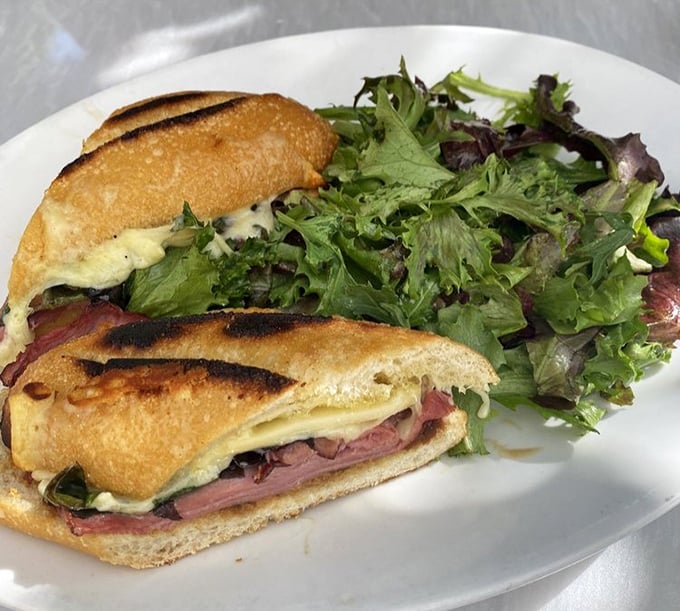 The pressed duck sandwich isn't just lunch—it's an event. Perfectly grilled bread embracing tender duck meat with melty cheese and fresh greens. Worth crossing county lines for.
