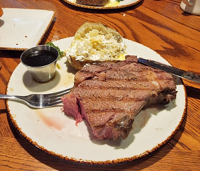 This prime rib doesn't need a filter or fancy lighting – just a sharp knife and your undivided attention. The baked potato stands by, ready for its supporting role.