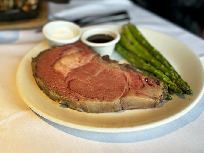 Behold the prime rib in all its glory—a masterpiece of meat so perfectly cooked it makes vegetarians question their life choices, if only momentarily.