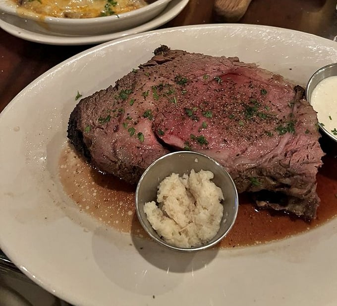Behold the prime rib that launches a thousand road trips – perfectly crusted, impossibly tender perfection.