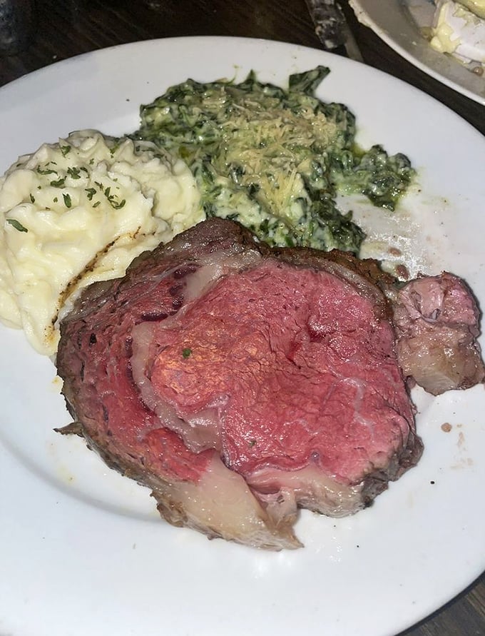 Prime rib perfection—a rosy center surrounded by a savory crust, flanked by creamy mashed potatoes and spinach that would make Popeye weep with joy.