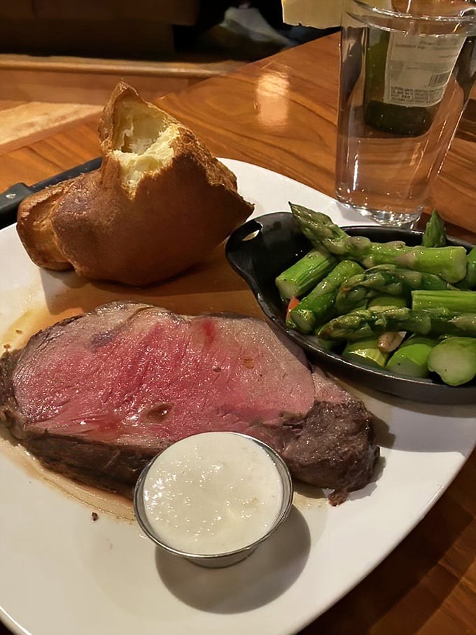 Behold the prime rib in all its glory – perfectly pink, accompanied by a popover that's practically begging to soak up that savory jus.