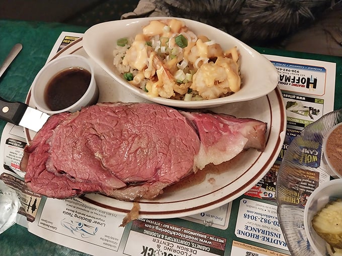 This isn't just prime rib—it's a masterpiece of meat, perfectly pink and paired with what appears to be a loaded potato side that's practically begging to be devoured.