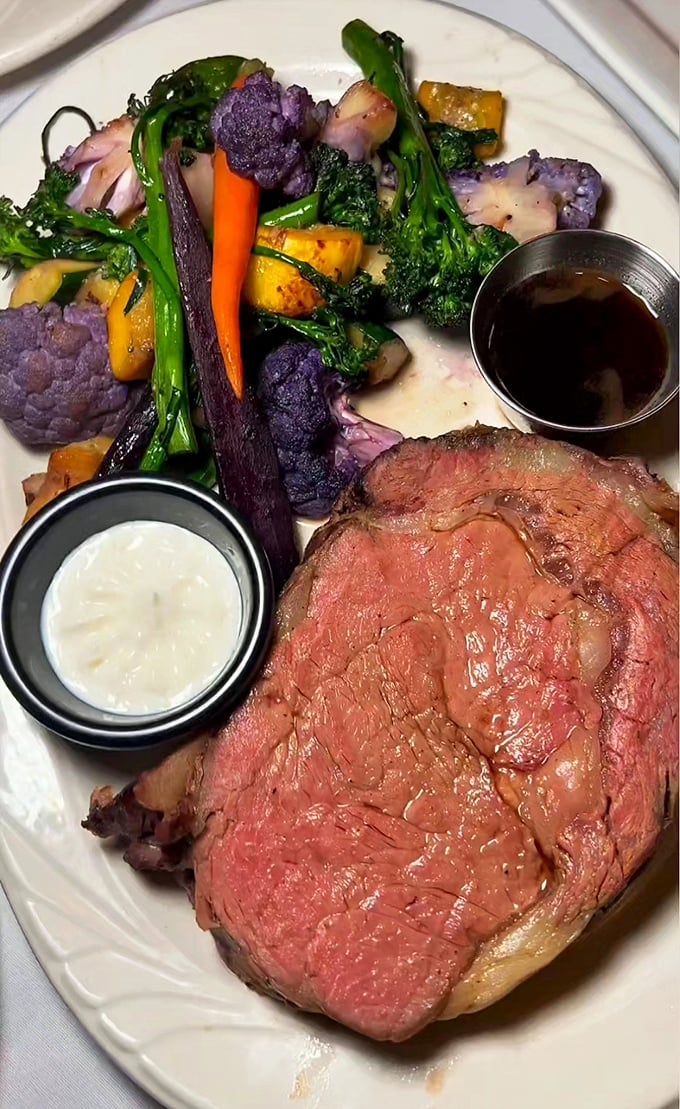 A perfectly medium-rare prime rib alongside colorful seasonal vegetables. This isn't just dinner—it's edible artwork with a side of pure joy.