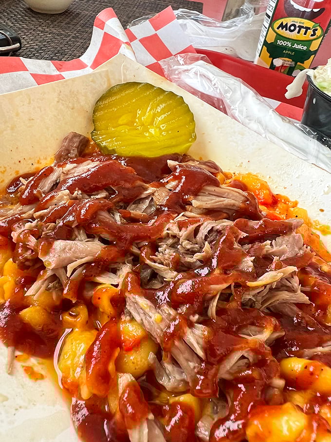 Pulled pork piled high atop mac and cheese with a pickle sentinel standing guard—a combination that makes taste buds stand at attention.