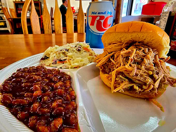 This isn't just a sandwich—it's edible architecture. Pulled pork piled high with slaw and beans that would make any Southerner nod in approval.