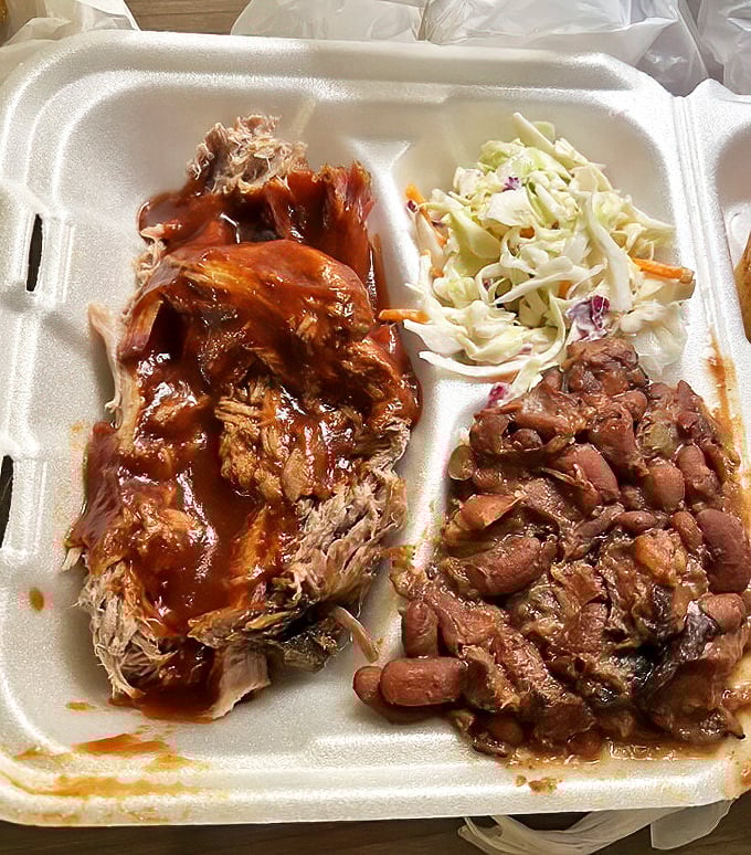 Pulled pork so tender it practically surrenders to your fork, glistening with sauce that strikes the perfect balance between sweet and tangy.