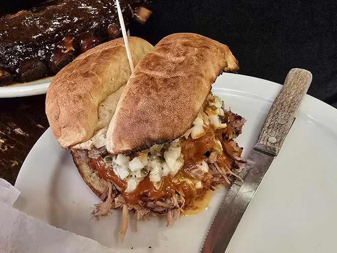 The sandwich that launched a thousand road trips. Tender pulled pork on pillowy bread with that signature sauce – resistance is futile.