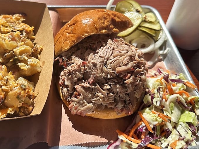 This pulled pork sandwich isn't just a meal, it's a masterclass in texture – tender strands of smoky meat practically begging to be devoured.