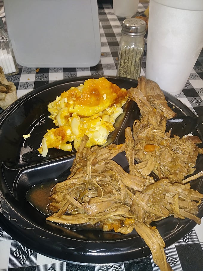 Behold the star attraction—pulled pork so tender it practically surrenders to your fork, paired with mac and cheese that would make grandma jealous.