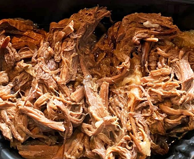 Pulled pork so tender it practically surrenders to your fork. This isn't just meat—it's a masterclass in patience and smoke.