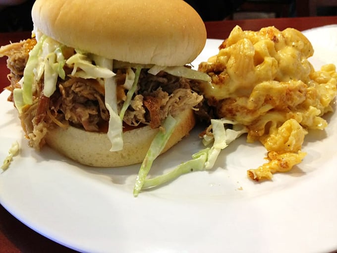 This pulled pork sandwich isn't just food—it's architecture, with perfectly smoked meat, crisp slaw, and a side of mac and cheese that deserves its own zip code.