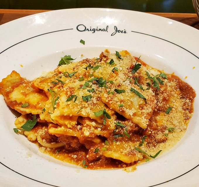 Ravioli that would make your Italian grandmother weep with joy—pillows of pasta perfection crowned with fresh herbs and a shower of Parmesan.