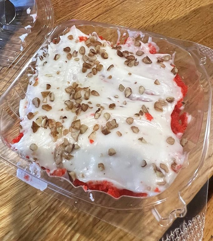 The legendary red velvet cake in its natural habitat. Those pecans on top aren't just garnish—they're the crown jewels.