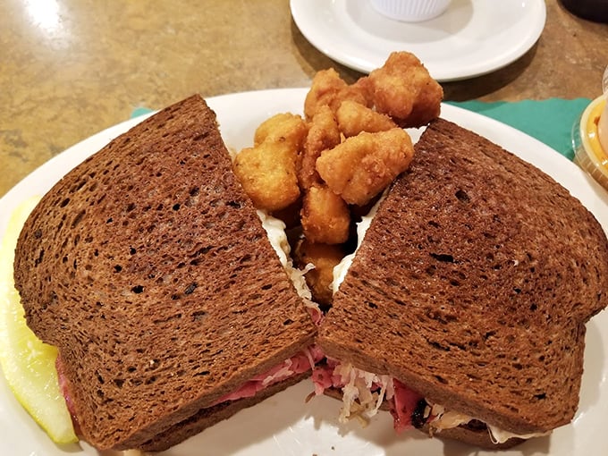 Behold the Reuben that launched a thousand return visits – perfectly grilled rye embracing corned beef perfection.