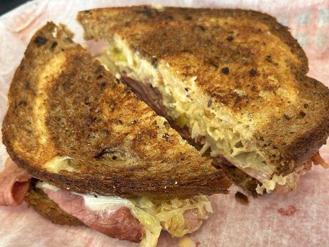 This isn't just a Reuben—it's a masterclass in sandwich architecture where corned beef, sauerkraut, and Russian dressing achieve perfect harmony.