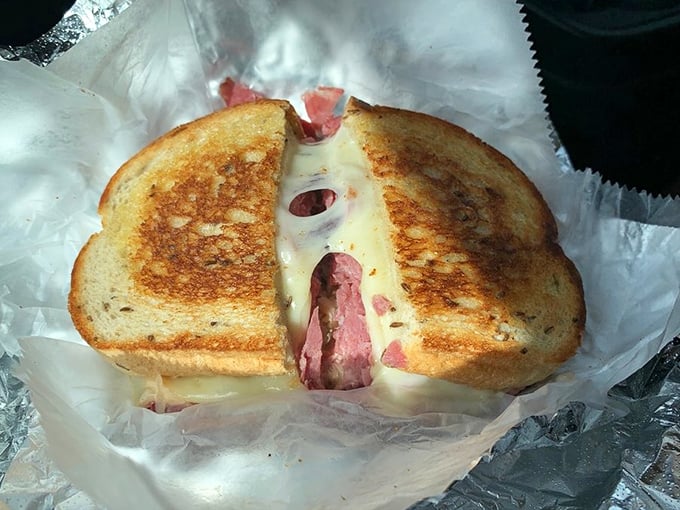 Behold the Reuben in its natural habitat—perfectly grilled rye embracing corned beef and Swiss in a melty marriage that makes you want to renew your vows with lunch.