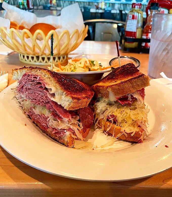 This isn't just a sandwich—it's a skyscraper of corned beef, sauerkraut, and melted Swiss that requires a game plan before eating.