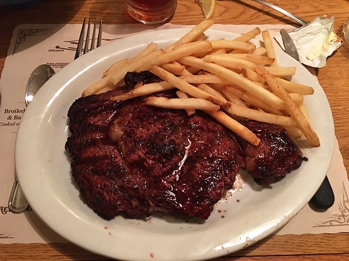 Behold the star of the show: a perfectly charred ribeye with golden fries. This isn't Instagram food—it's the real deal that makes your phone irrelevant.