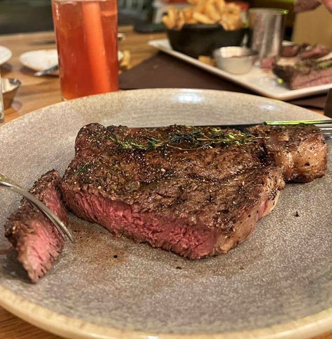 This perfectly seared ribeye isn't just dinner—it's a masterclass in temperature control, with that rosy interior making carnivores weak at the knees.