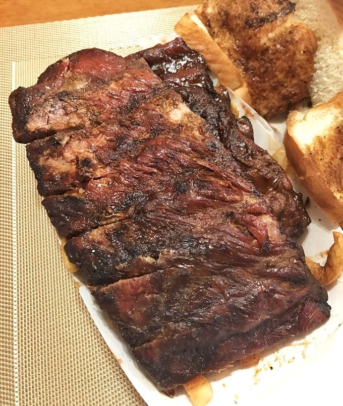 These ribs aren't just smoked, they're transformed—the bark so perfect you'd think it was carved by a barbecue Michelangelo.