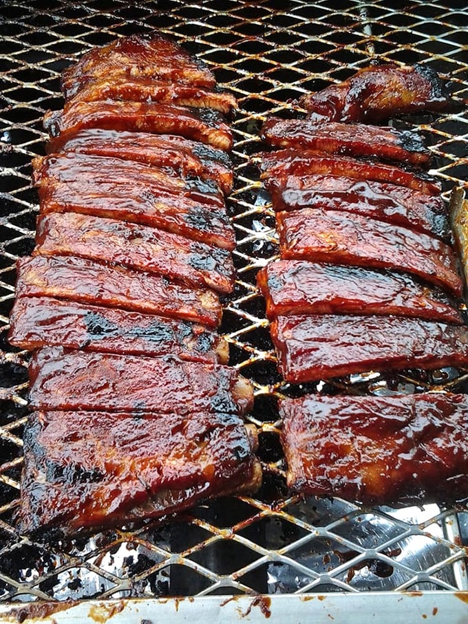 These ribs aren't just cooked; they're coaxed into tenderness through a slow dance of smoke and time. That glaze isn't sauce—it's edible stained glass.