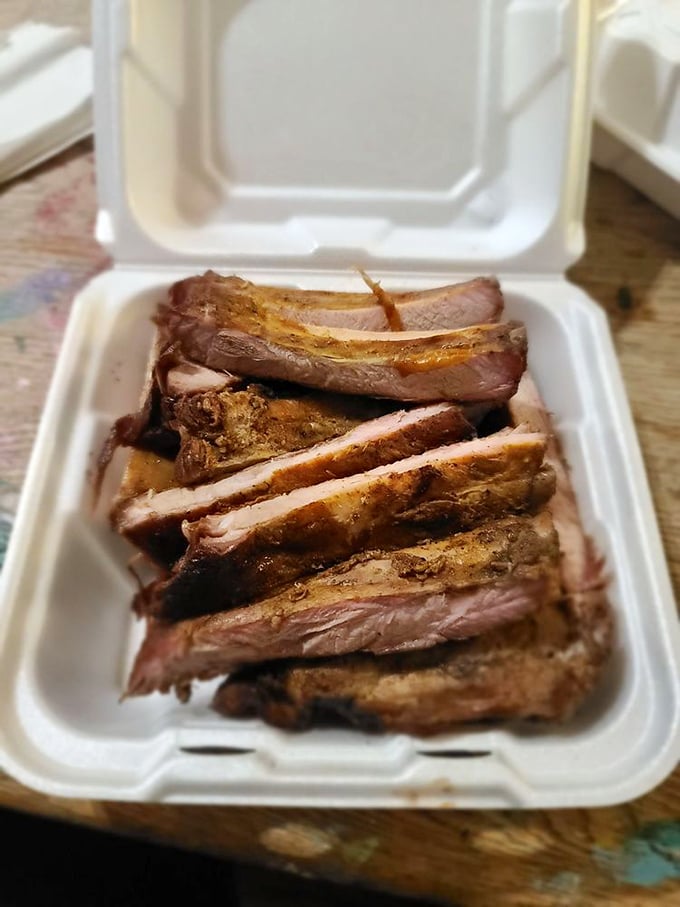 These ribs aren't just cooked—they're transformed. The perfect pink smoke ring tells the story of patience and expertise.