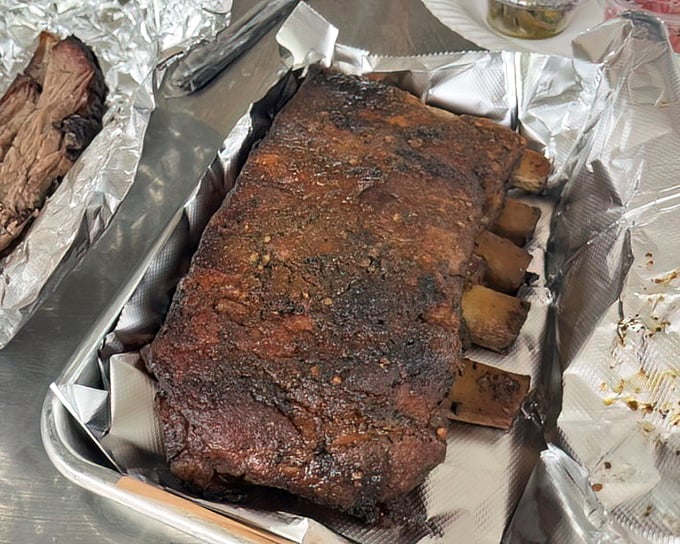 Behold the holy grail of BBQ – perfectly smoked ribs with that coveted pink smoke ring and bark that would make a tree jealous. Napkins required, no apologies necessary.