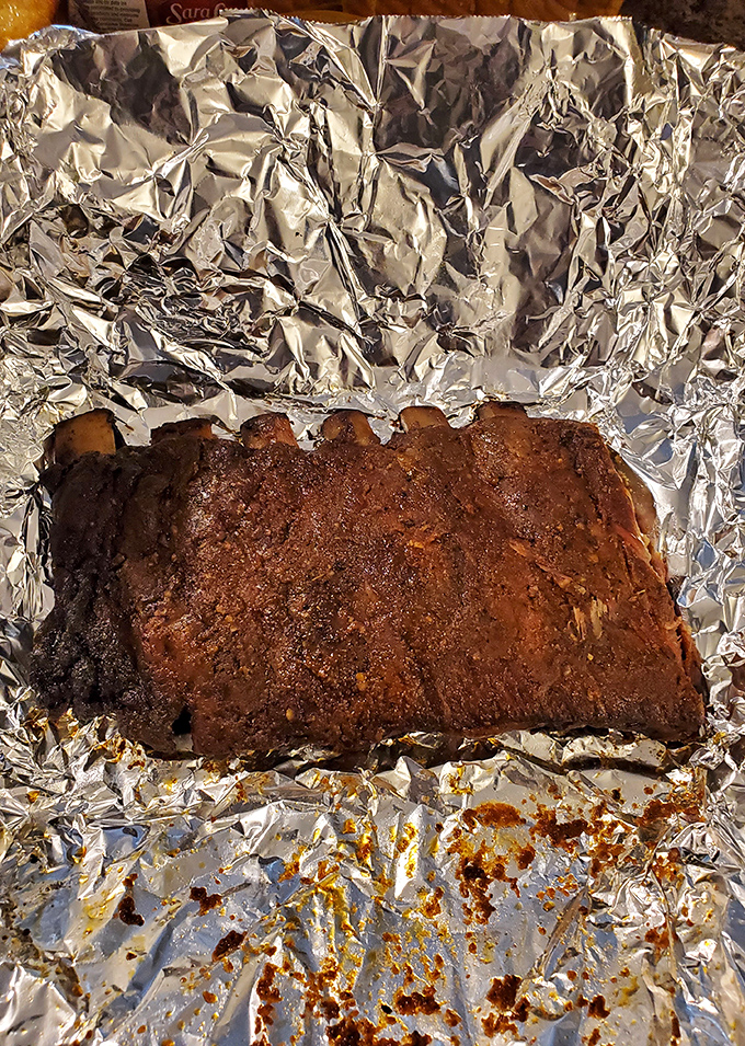 These ribs aren't just smoked; they're transformed into something transcendent. That bark, that color—this is what barbecue dreams are made of.