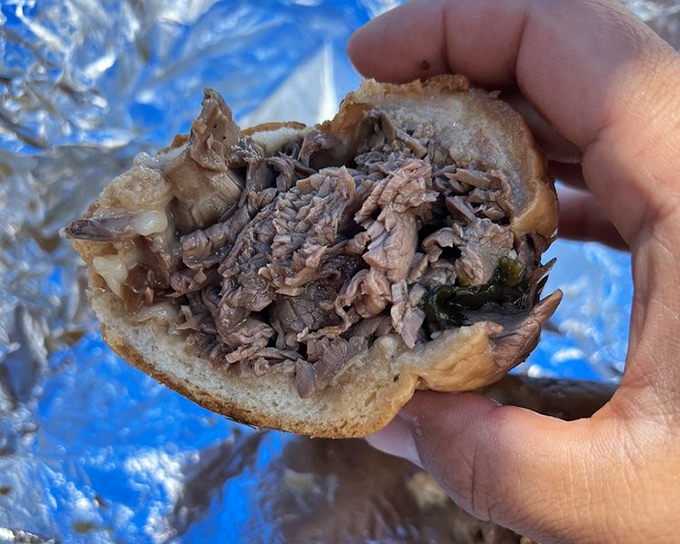 Behold the roast beef in its natural habitat—tender, perfectly seasoned meat nestled in a roll that's somehow both sturdy and yielding. Poetry in sandwich form.