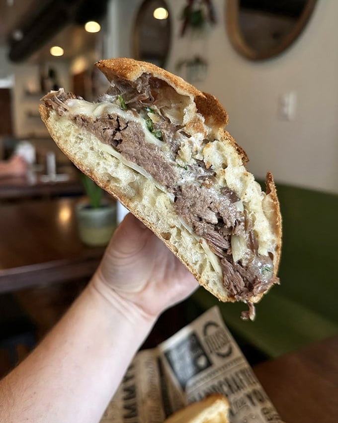 Behold the star of the show—a roast beef sandwich that's architectural in its layering, with meat so tender it practically surrenders at first bite.
